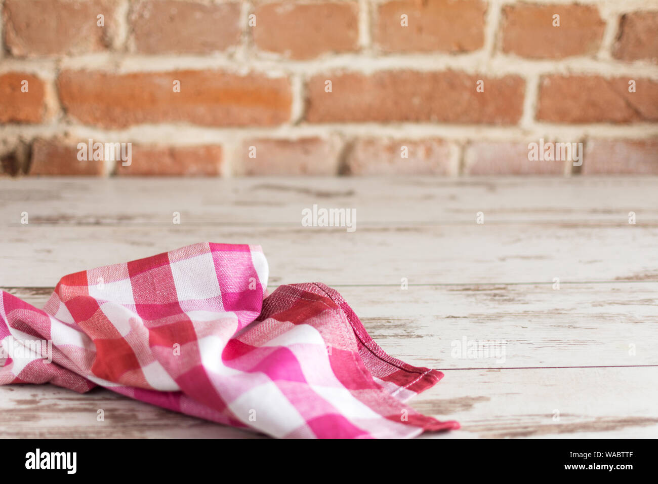 Red checkered napkin on wooden background Background with napkin ...