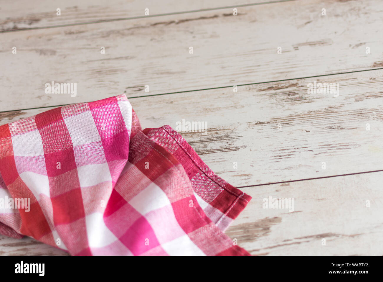 Red checkered napkin on wooden background Background with napkin ...