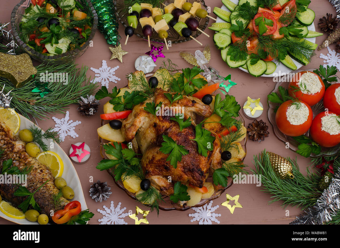 Christmas holiday table with chicken, fish, vegetables, canapes ...