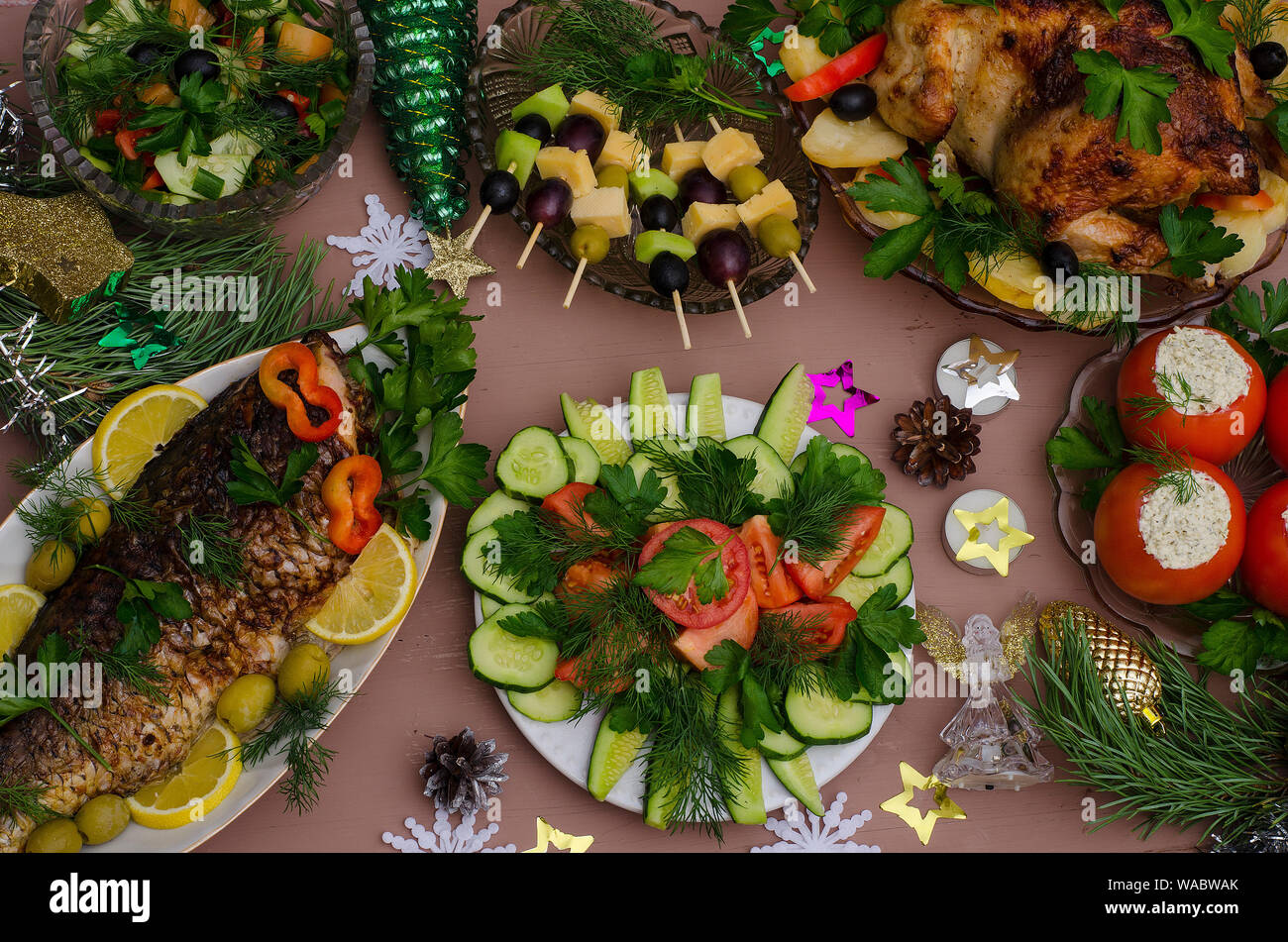 Christmas holiday table with chicken, fish, vegetables, canapes ...