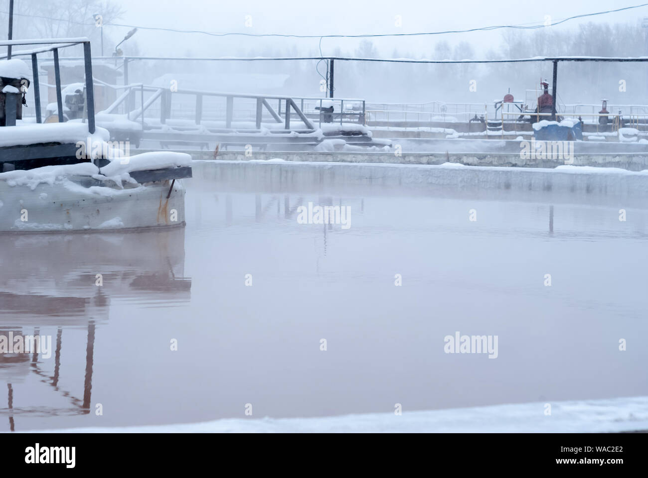 sewage treatment plant in winter, icy primary settling tanks Stock ...