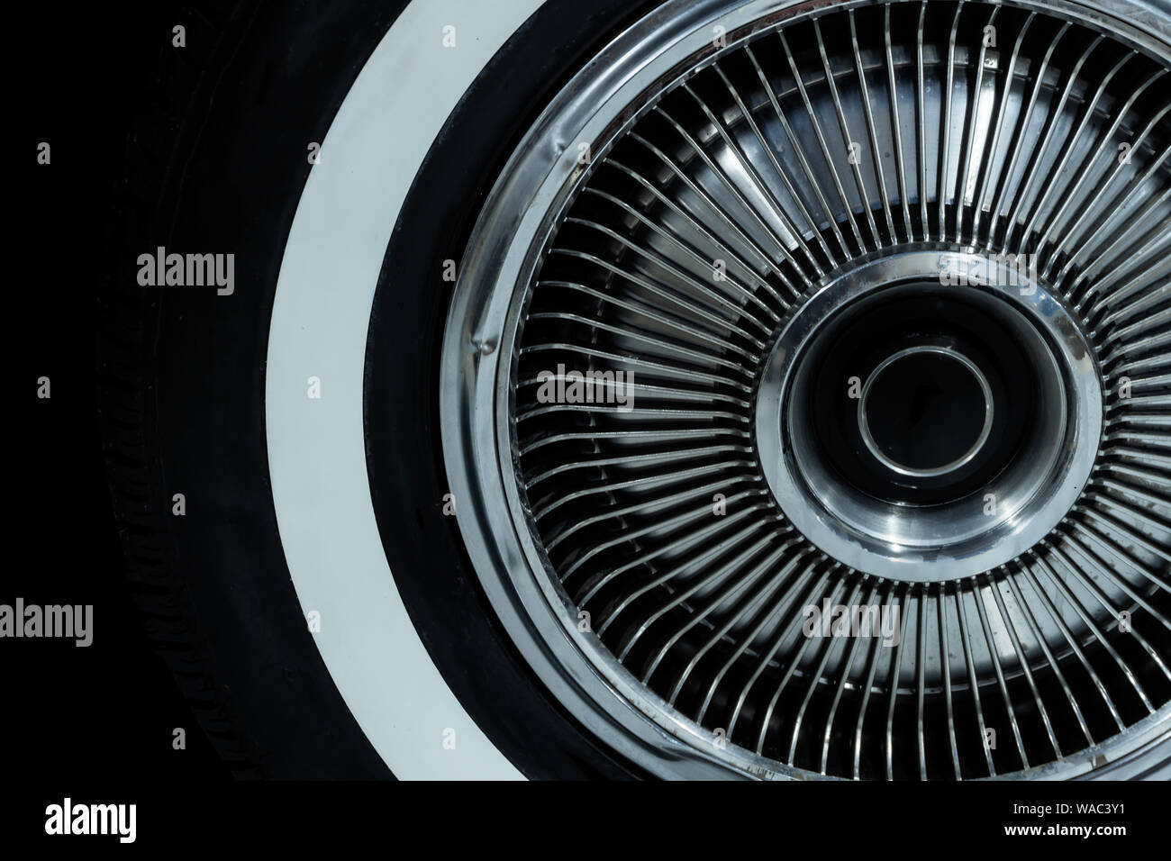 fragment of a vintage automobile wheel with a chrome-plated disc on a ...