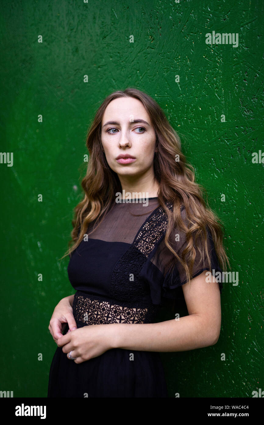 Portrait of a woman on a green background Stock Photo - Alamy