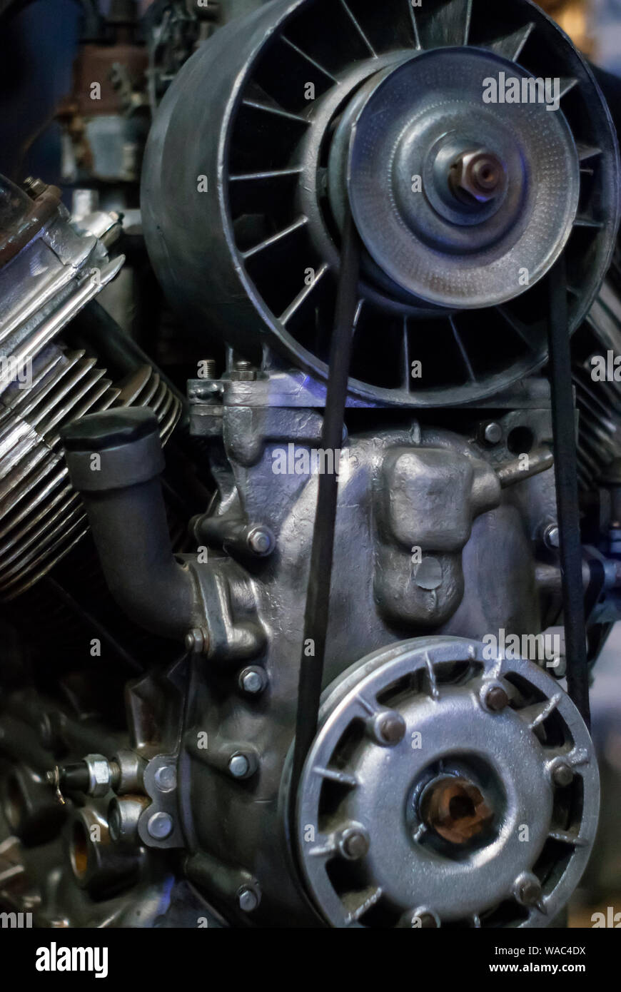 fragment of a semi-assembled old internal combustion engine on a dark ...