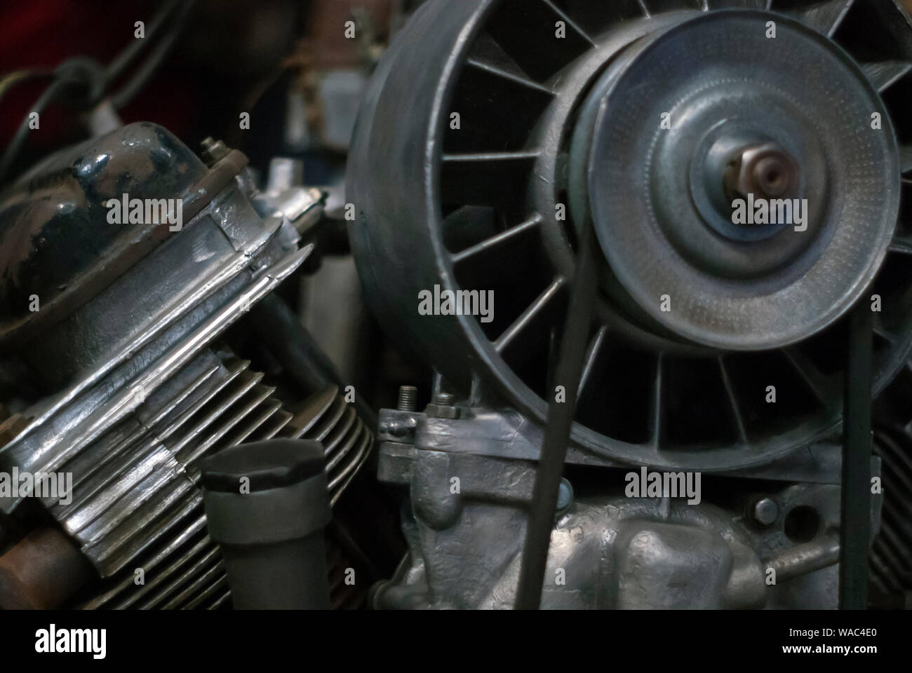 fragment of a semi-assembled old internal combustion engine on a dark ...