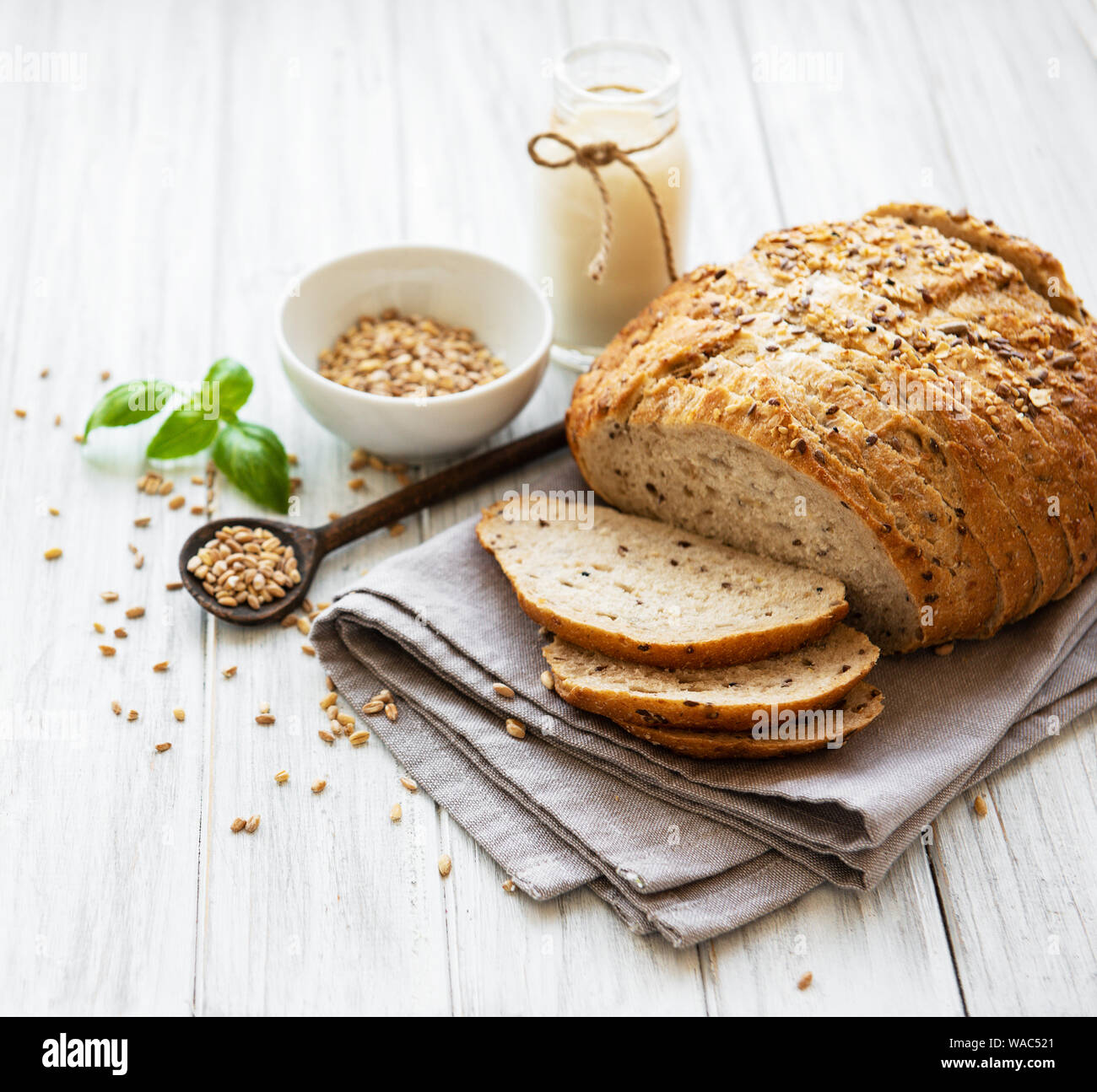 Glass of milk and bread on a white wooden table Stock Photo - Alamy