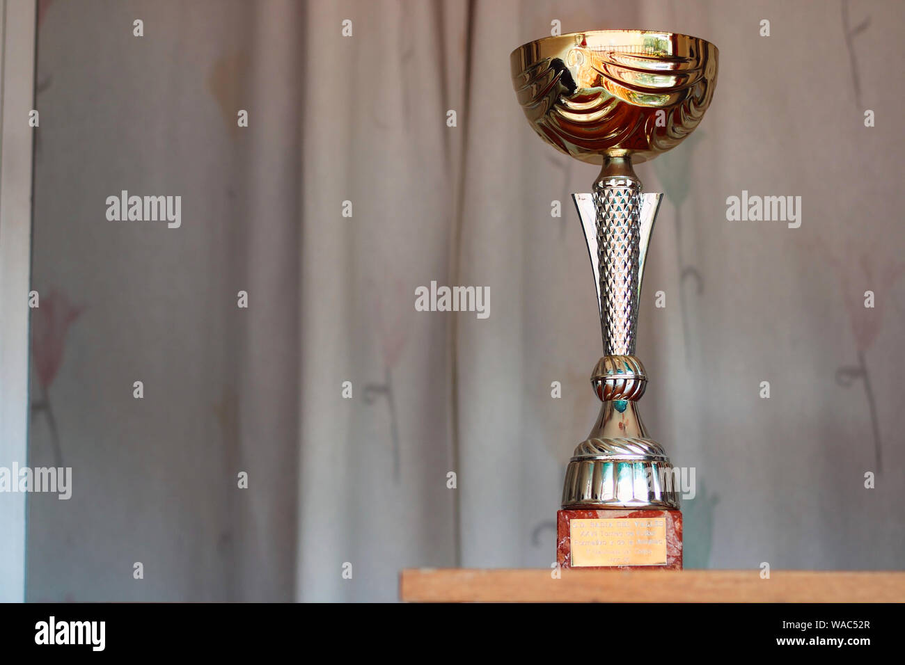 Big gold trophy on a white table Stock Photo - Alamy