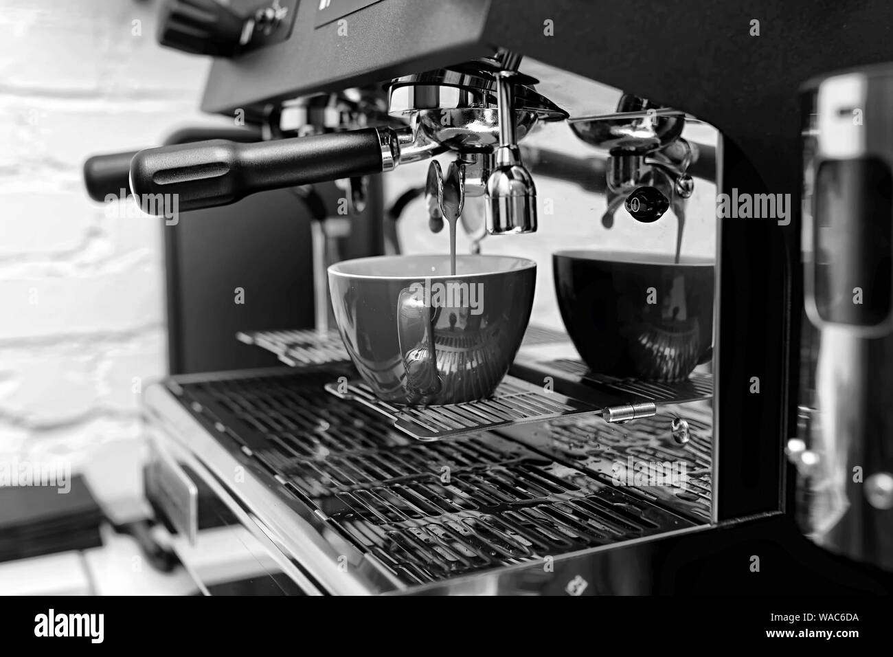 coffee machine preparing fresh coffee and pouring into red cups at ...