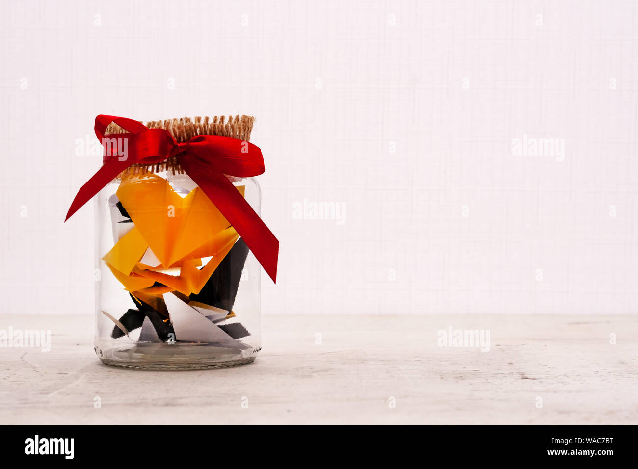 A glass jar with colored Airplanes of craft paper. Black and white ...
