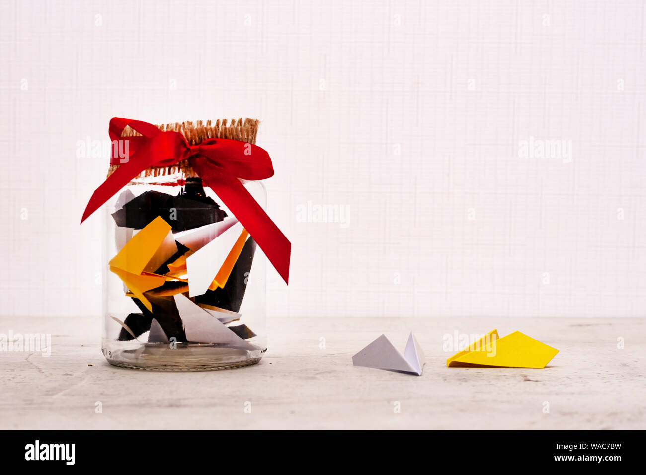 A glass jar with colored Airplanes of craft paper. Black and white ...