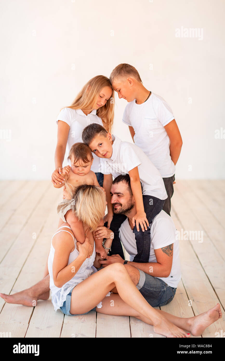 Big happy family with four kids having fun indoors. Big happy family ...