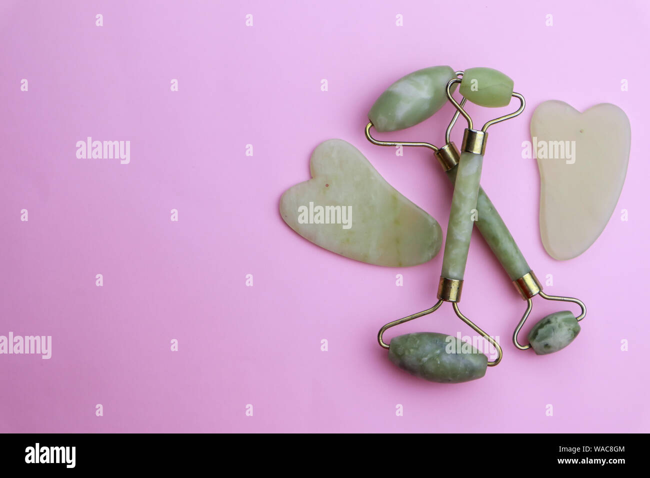 Facial and body stone massage instruments on color background Stock ...