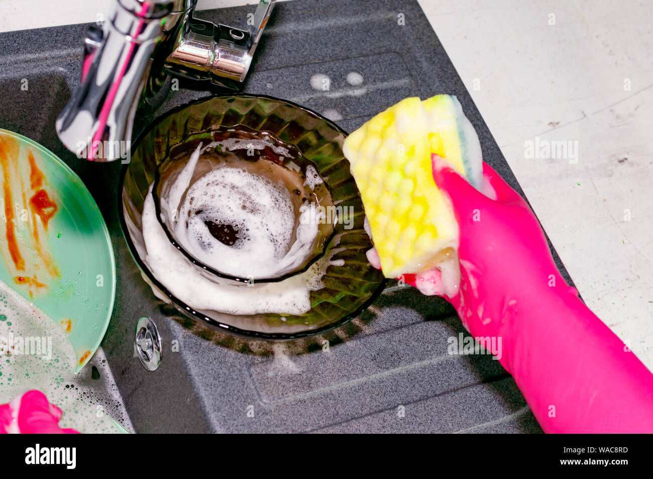 The process of washing plates in the sink, hands and plates closeup ...