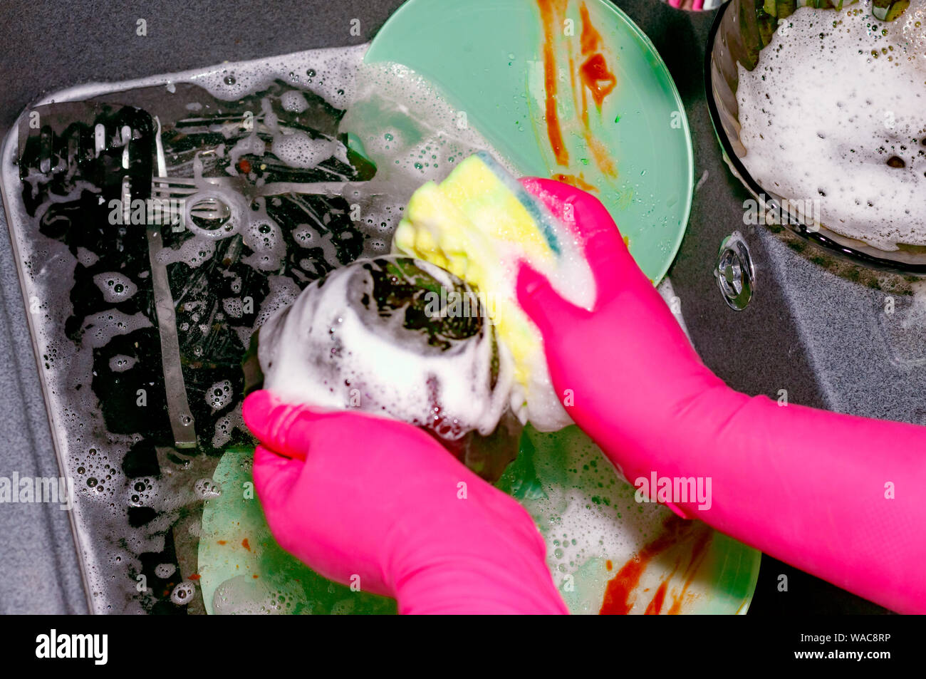 The process of washing plates in the sink, hands and plates closeup ...