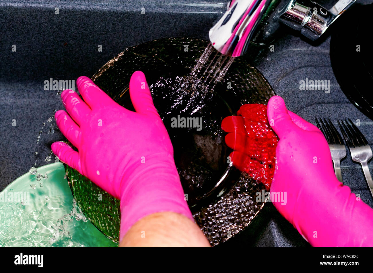The process of washing plates in the sink, hands and plates closeup ...