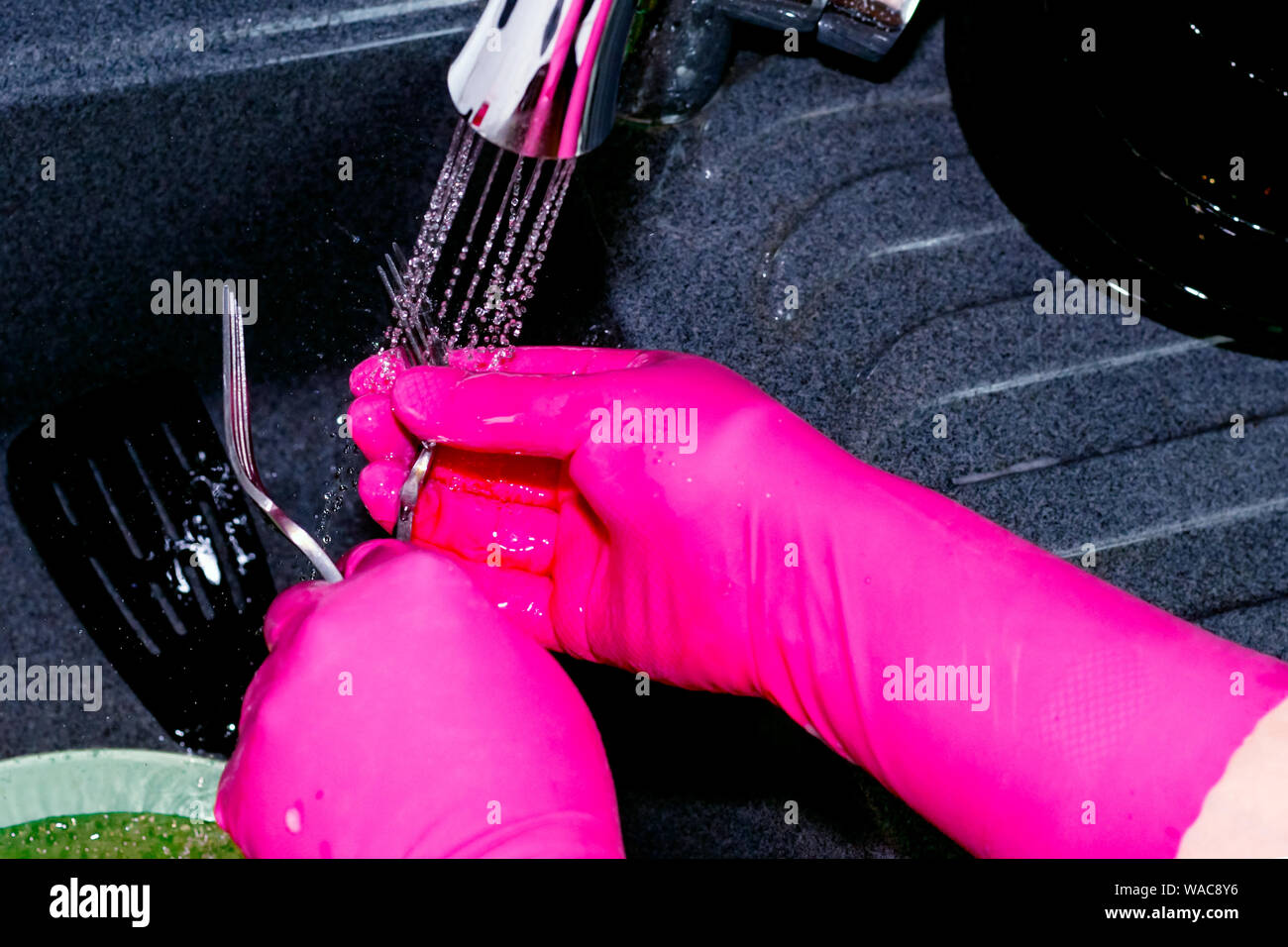 The process of washing plates in the sink, hands and plates closeup ...