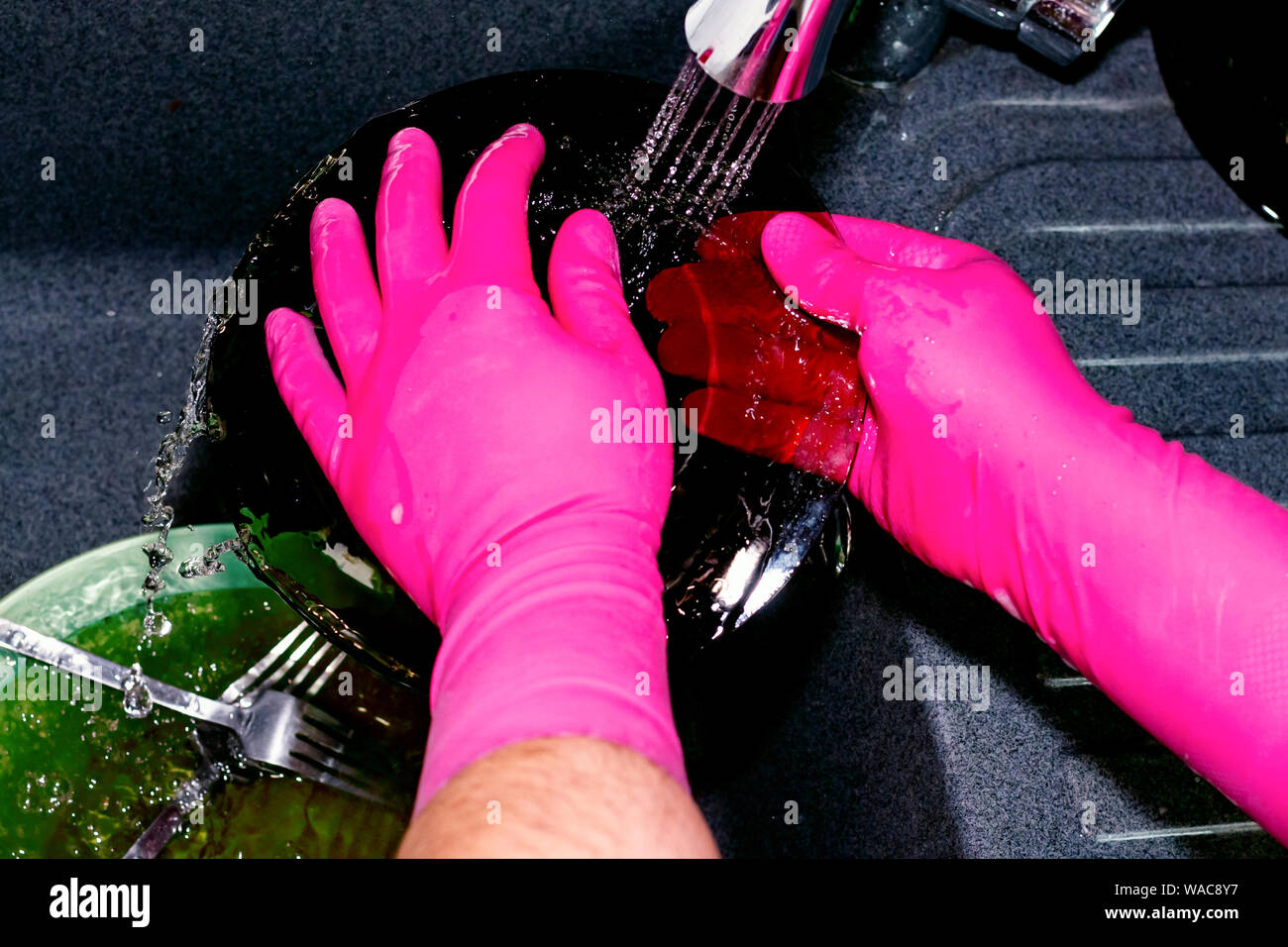 The process of washing plates in the sink, hands and plates closeup ...