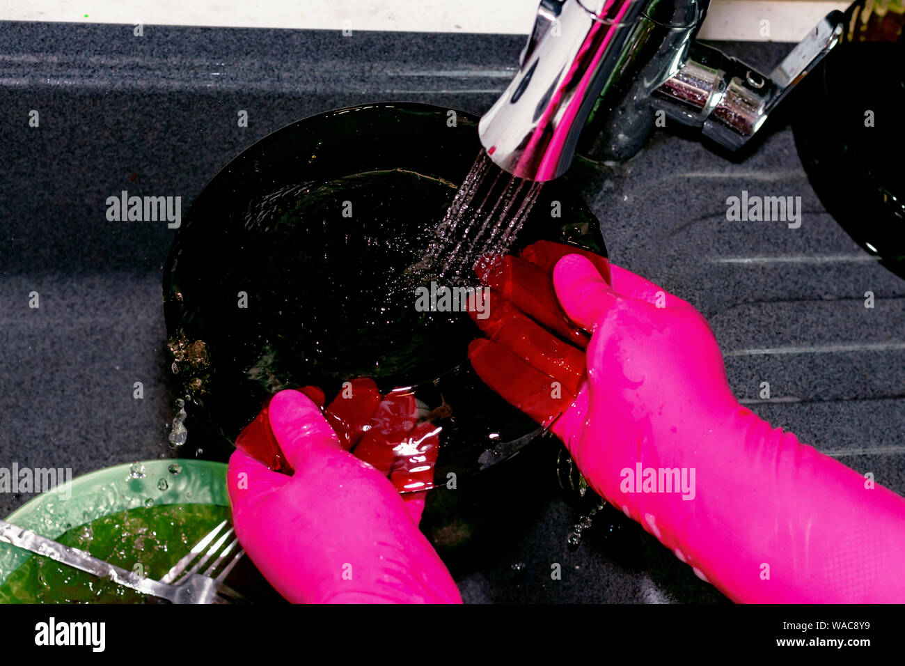 The process of washing plates in the sink, hands and plates closeup ...