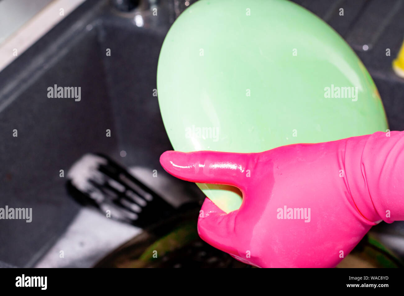 The process of washing plates in the sink, hands and plates closeup ...