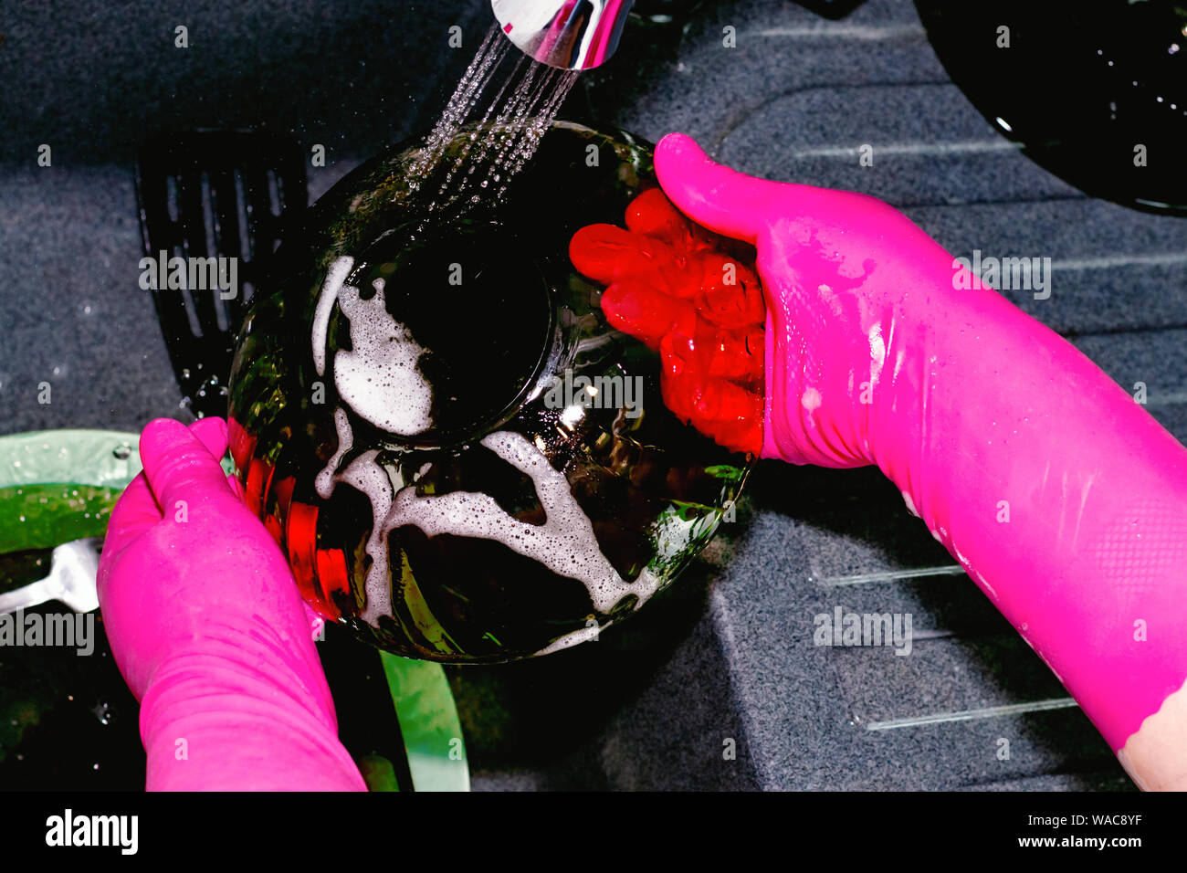 The process of washing plates in the sink, hands and plates closeup ...