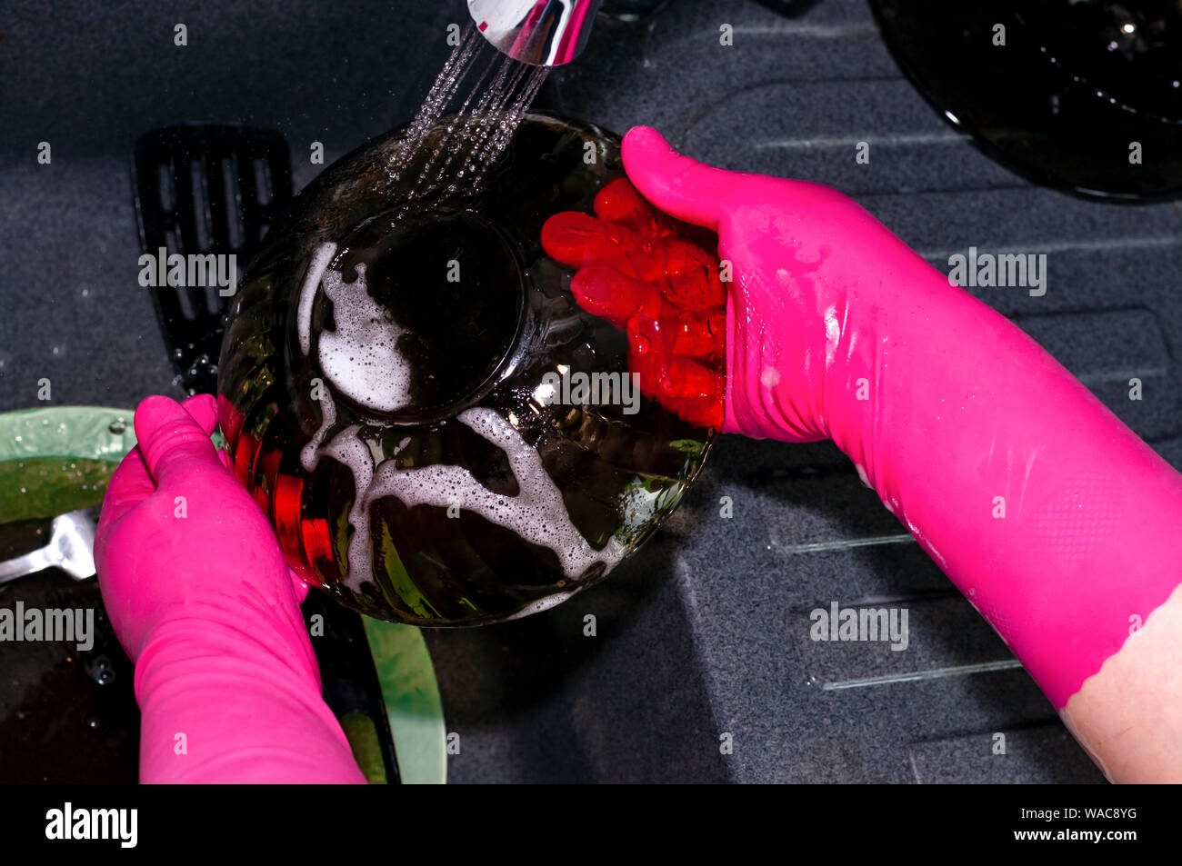 The process of washing plates in the sink, hands and plates closeup ...