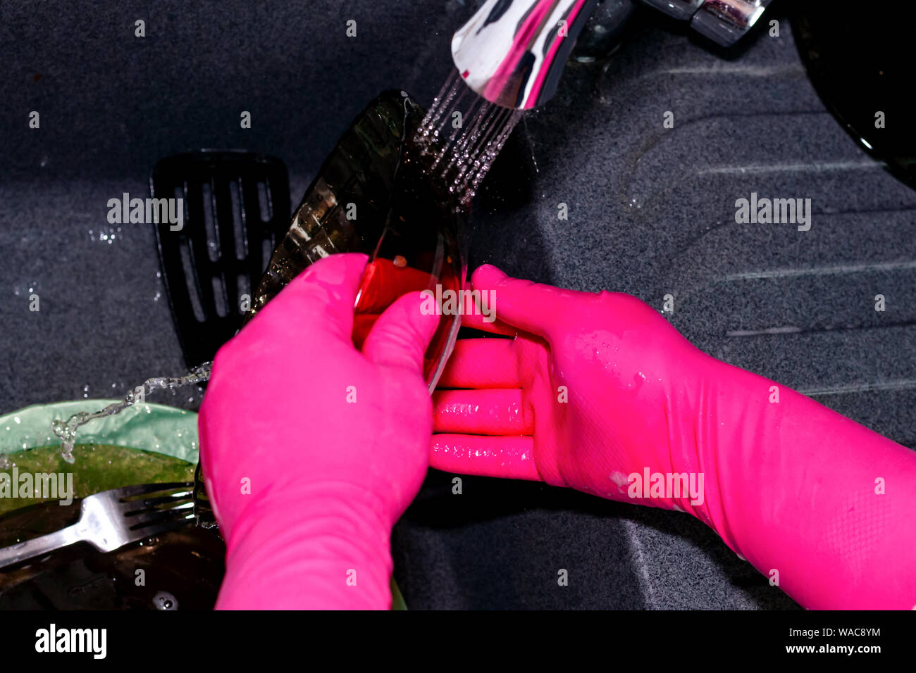 The process of washing plates in the sink, hands and plates closeup ...
