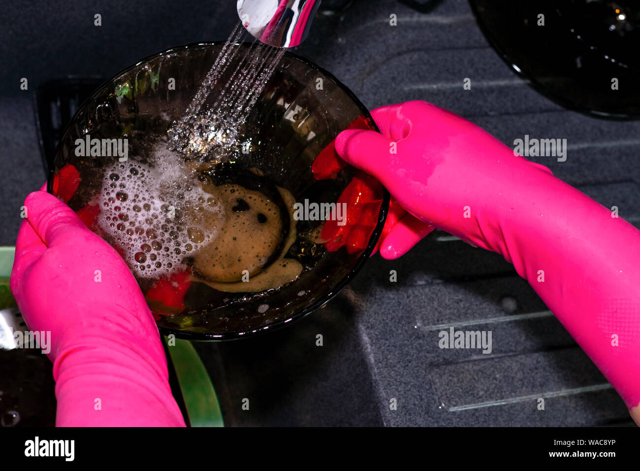 The process of washing plates in the sink, hands and plates closeup ...