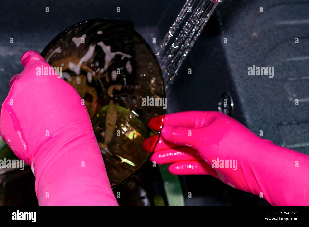 The process of washing plates in the sink, hands and plates closeup ...