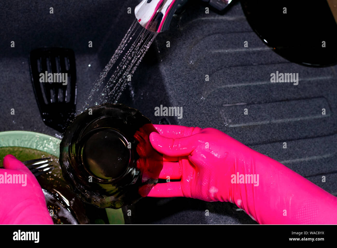 The process of washing plates in the sink, hands and plates closeup ...