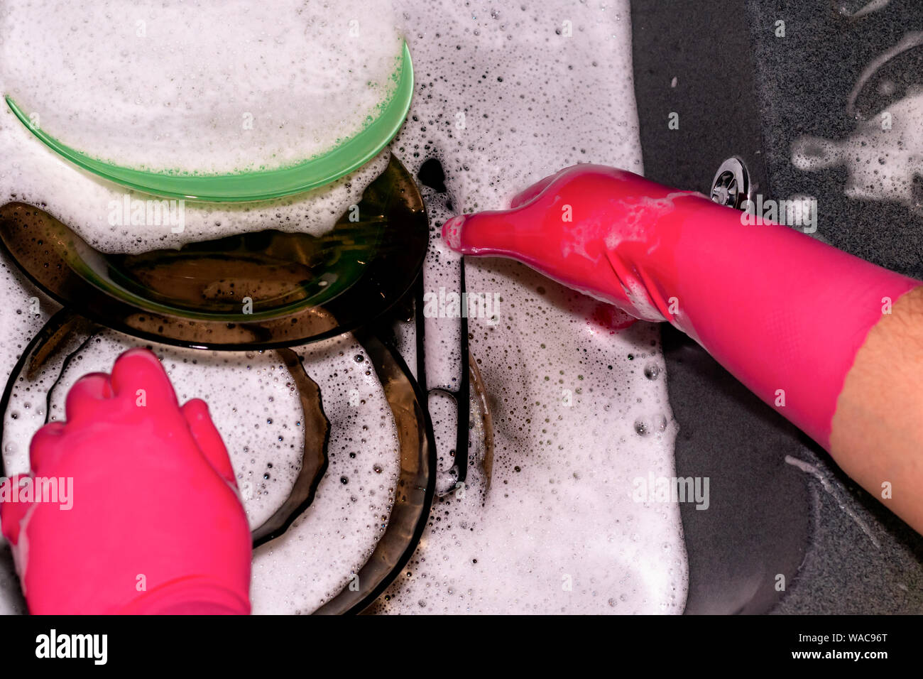 The process of washing plates in the sink, hands and plates closeup ...