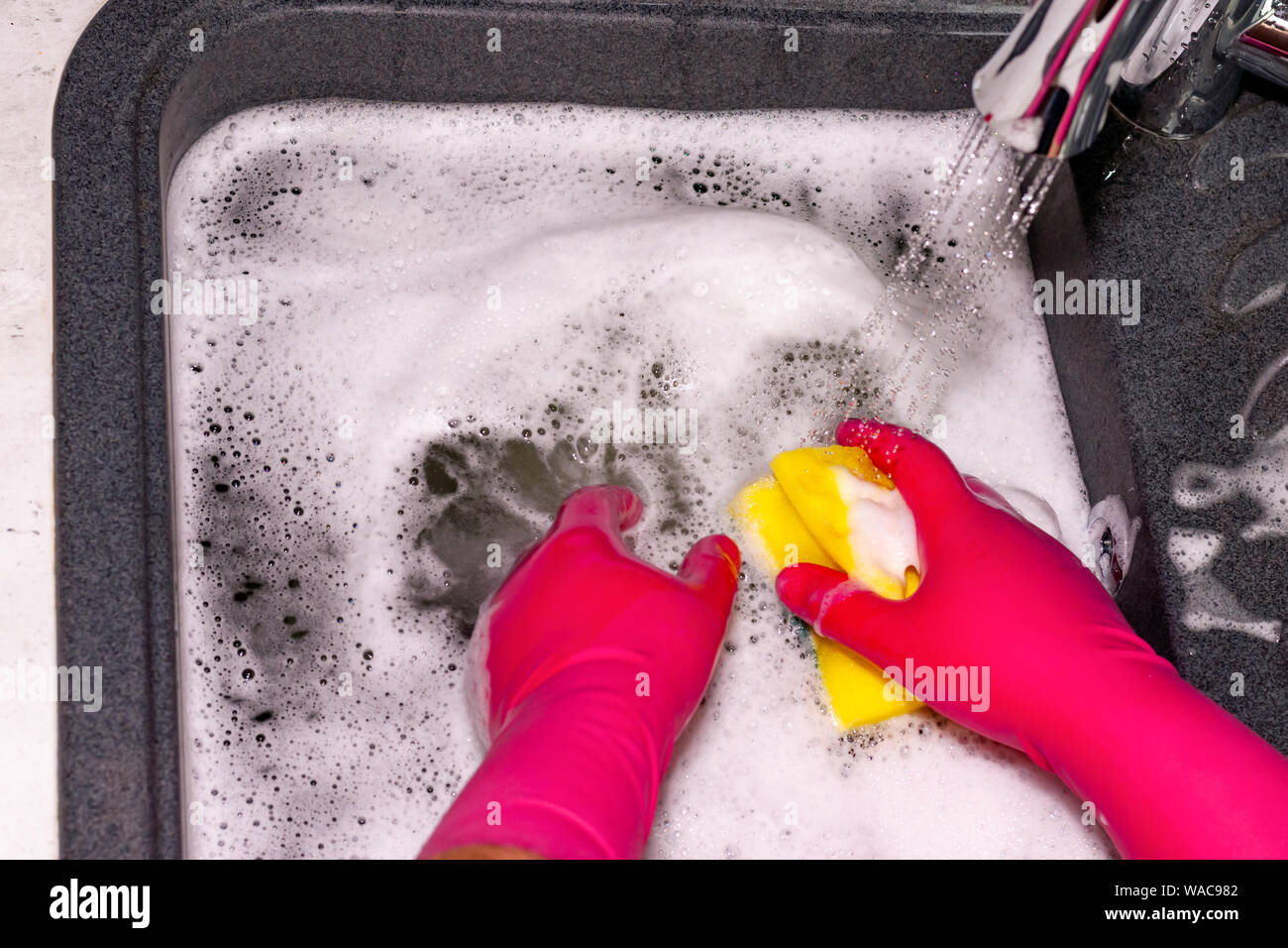 The process of washing plates in the sink, hands and plates closeup ...