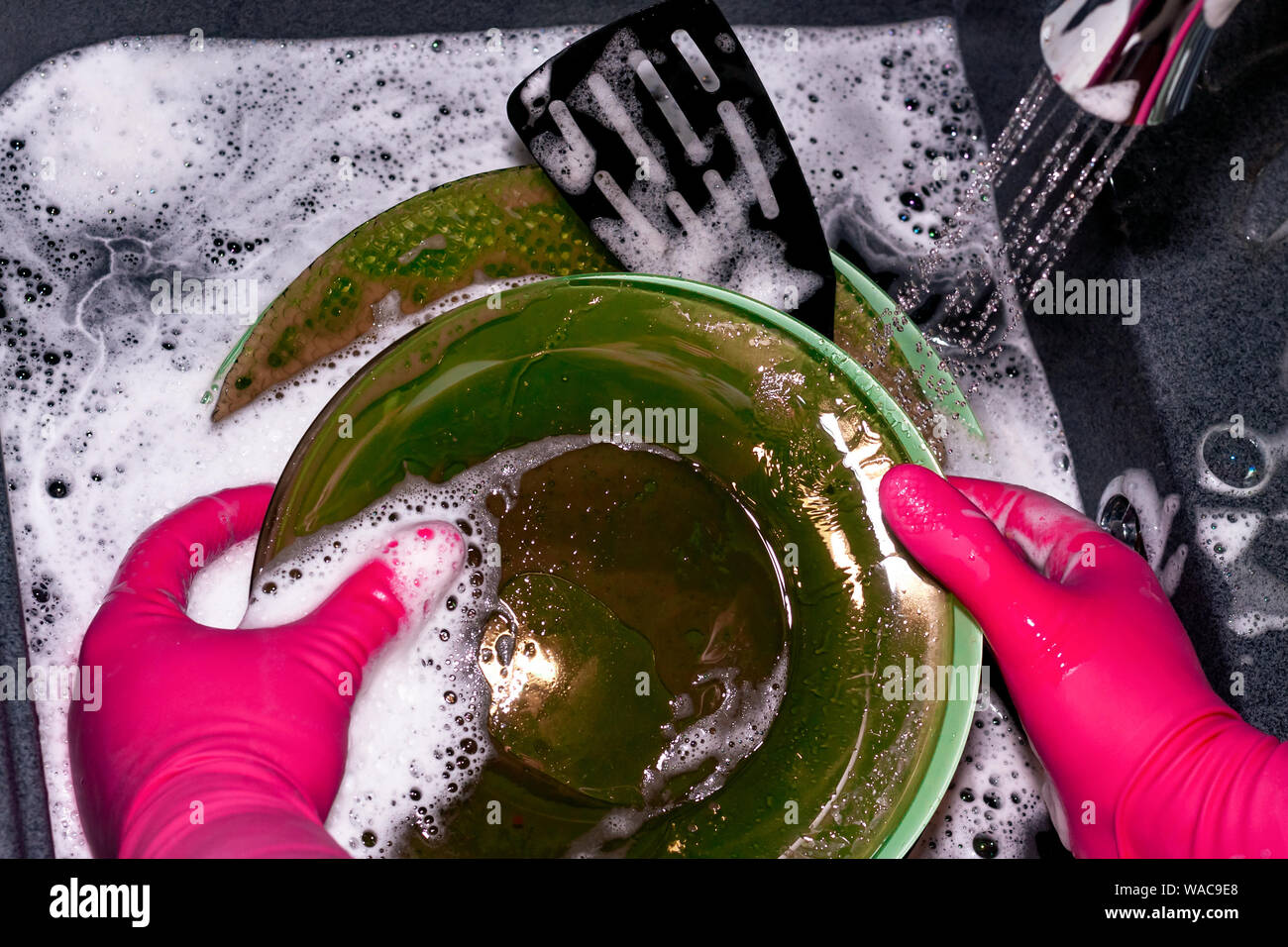 The process of washing plates in the sink, hands and plates closeup ...