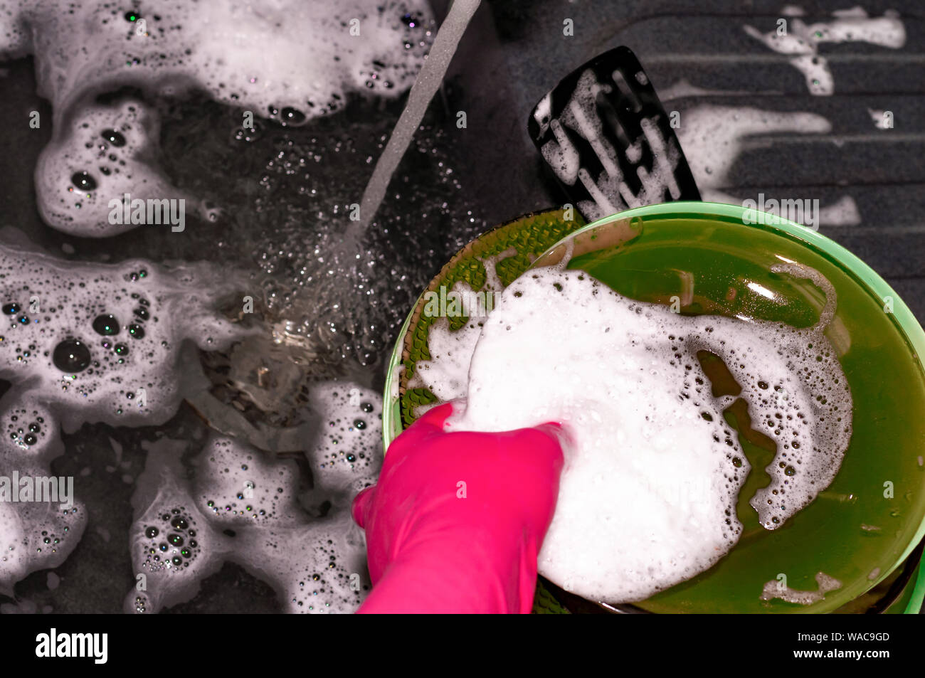The process of washing plates in the sink, hands and plates closeup ...