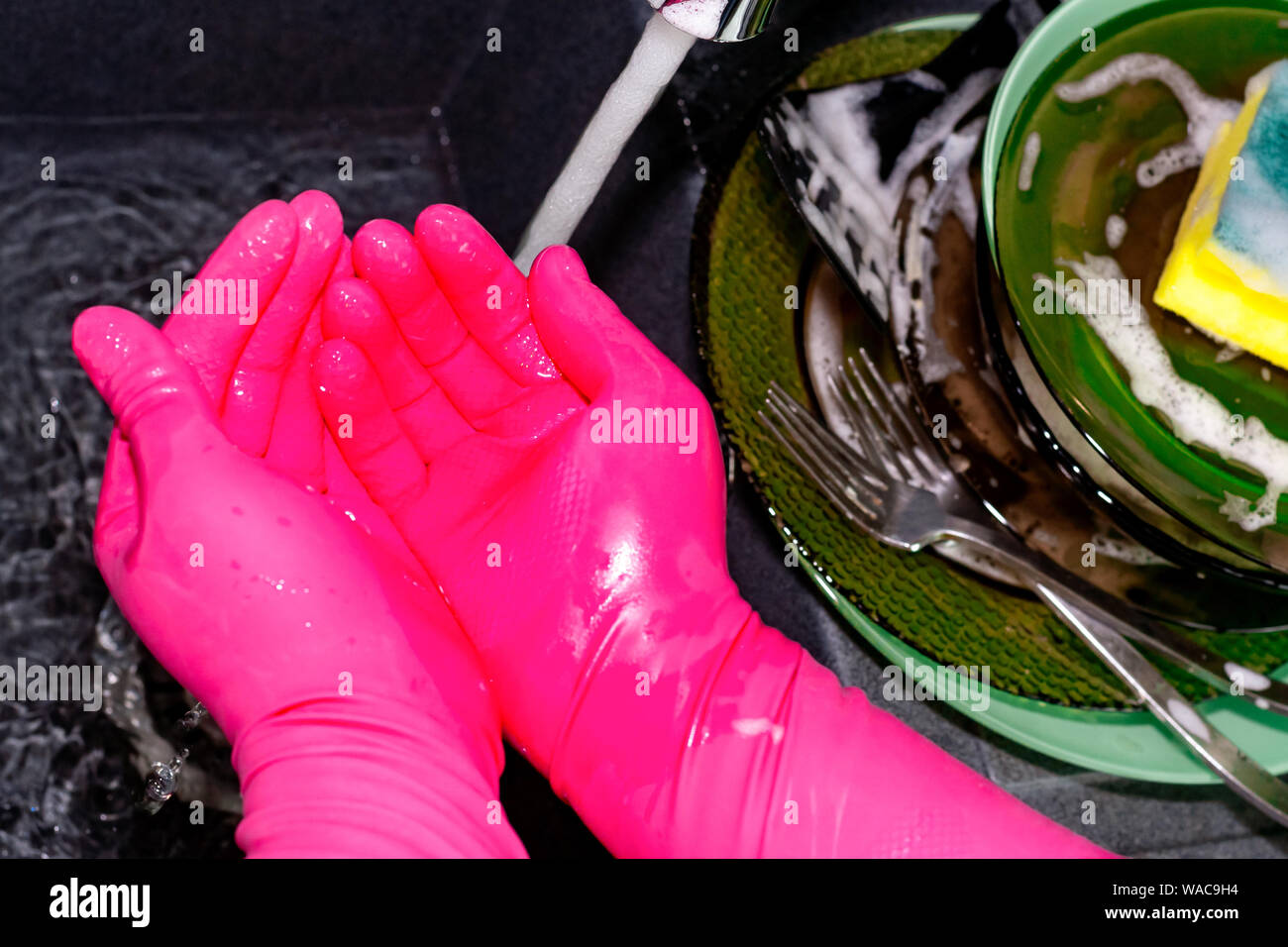 The process of washing plates in the sink, hands and plates closeup ...