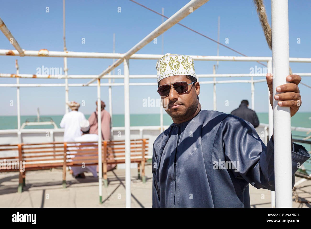 Local man in traditional clothes on car ferry boat to Masirah Island ...