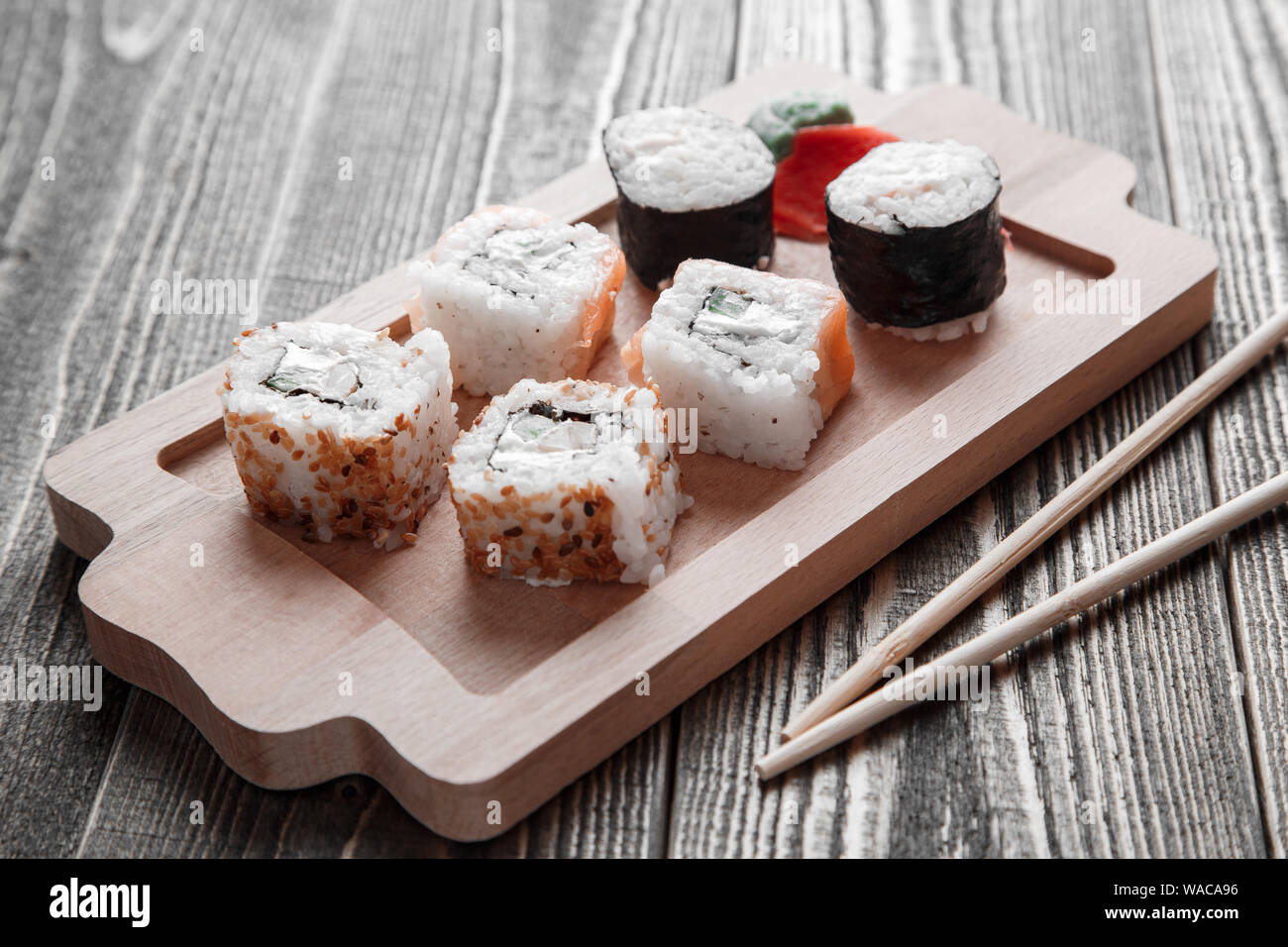 three different kinds of Japanese rolls with wasabi and ginger on ...