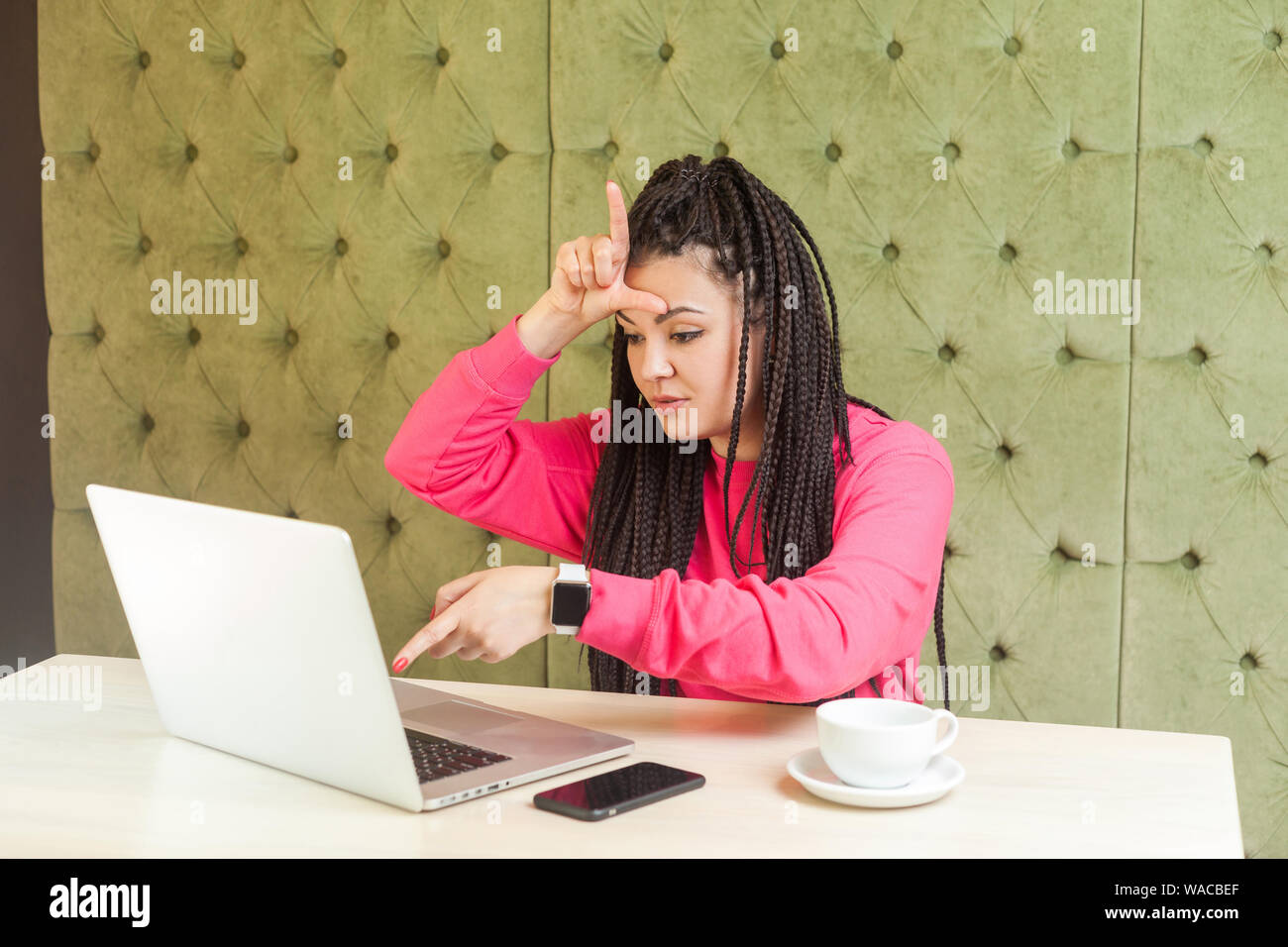 Loser! Portrait of unhappy rude young girl freelancer with black ...