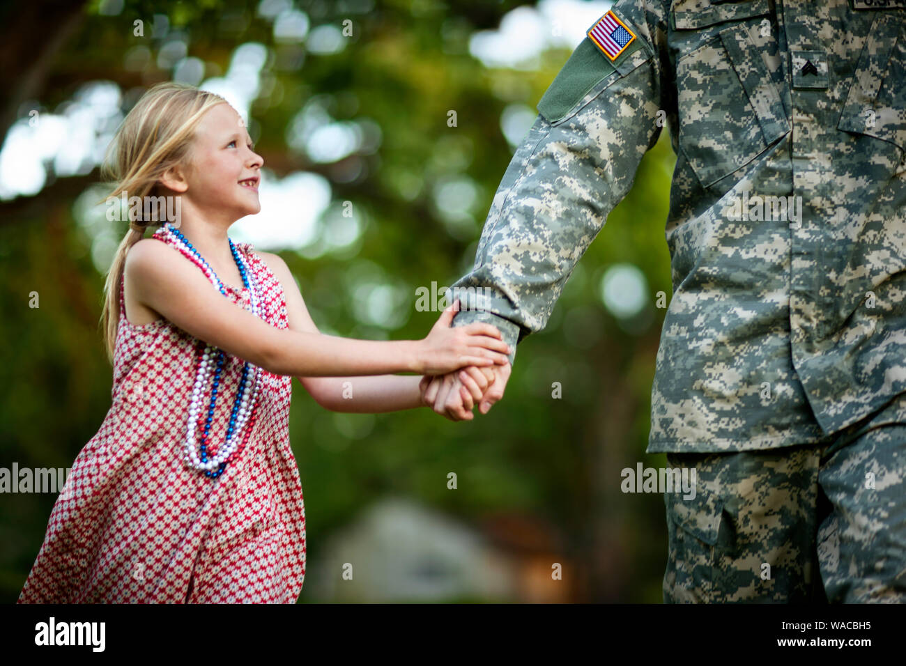 Young girl and mid adult man in army uniform smiling Stock Photo - Alamy