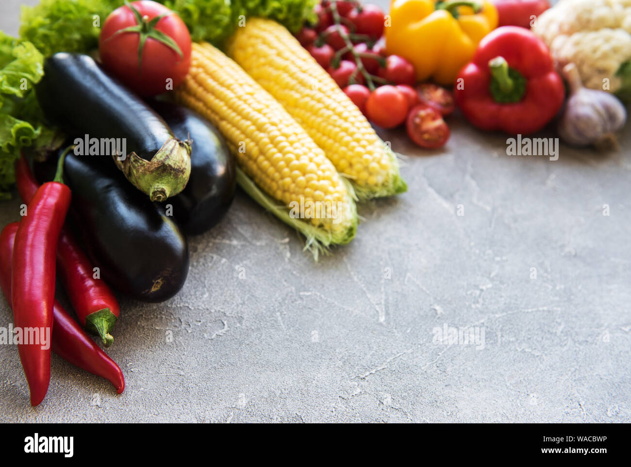 Fresh summer vegetables on a concrete background Stock Photo - Alamy