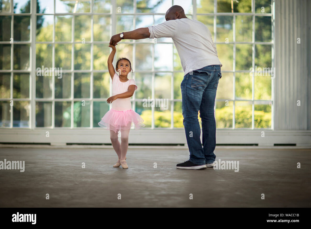 Father helping his daughter practice her ballet Stock Photo - Alamy