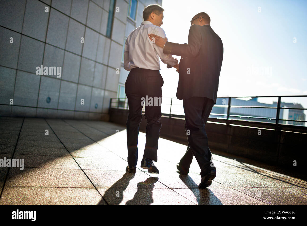Businessmen shaking hands on balcony Stock Photo - Alamy