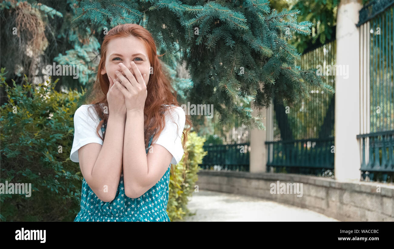 Smiling beautiful redhead woman covered mouth with laughter. Freckled ...