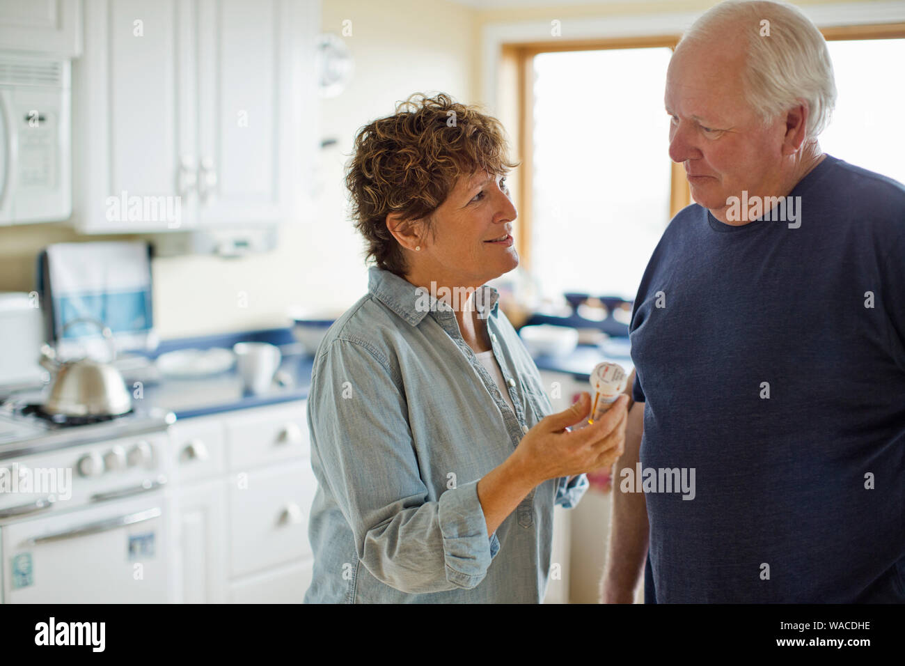 Mature woman discussing medication with her senior partner Stock Photo ...