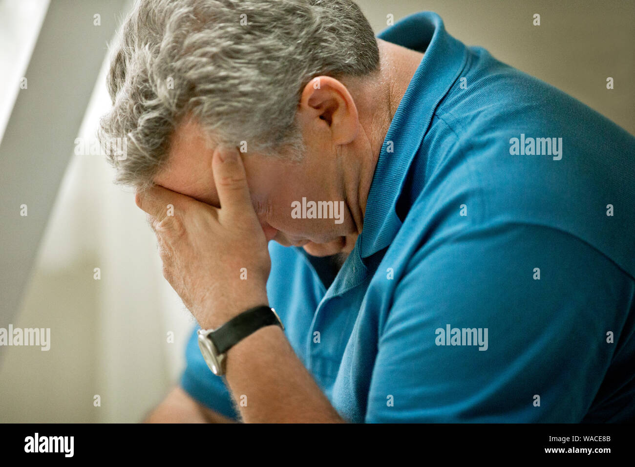 Man with his head in his hands hi-res stock photography and images - Alamy