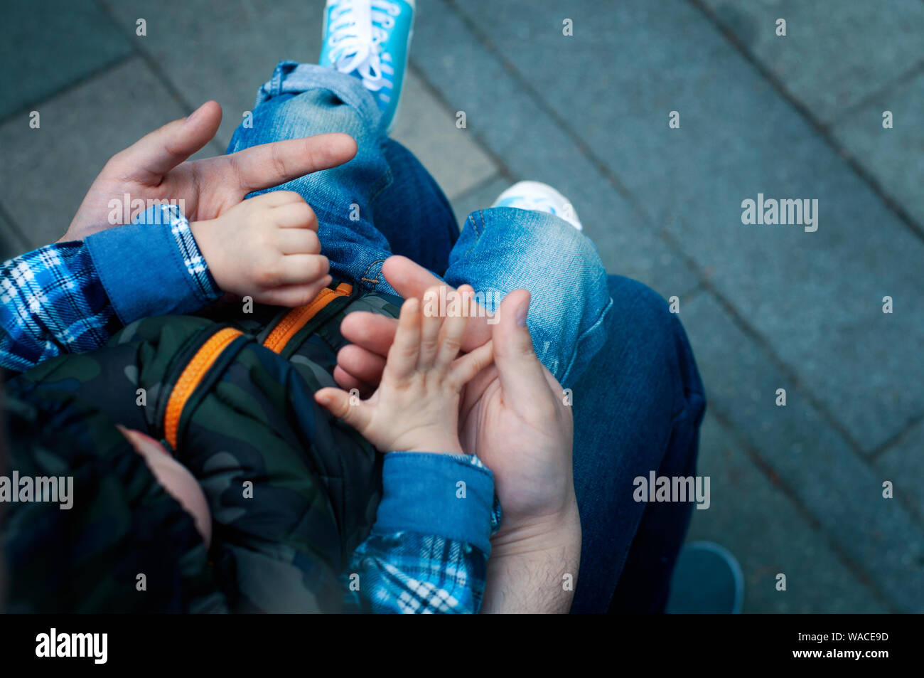 Son on his fathers lap in the park. paternity. Dad with a child on the ...