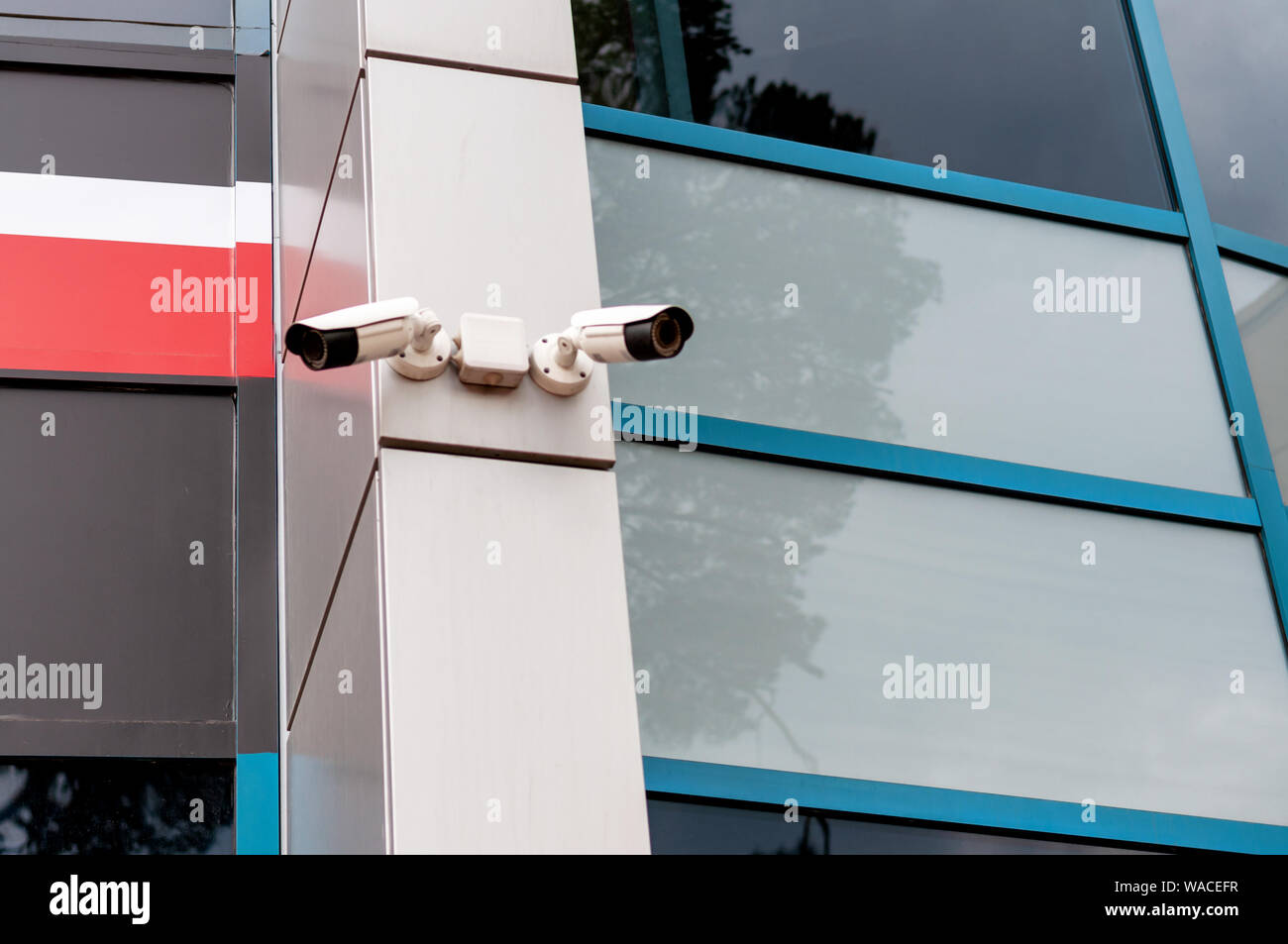 Two surveillance cameras on the corner of the house. Security and ...