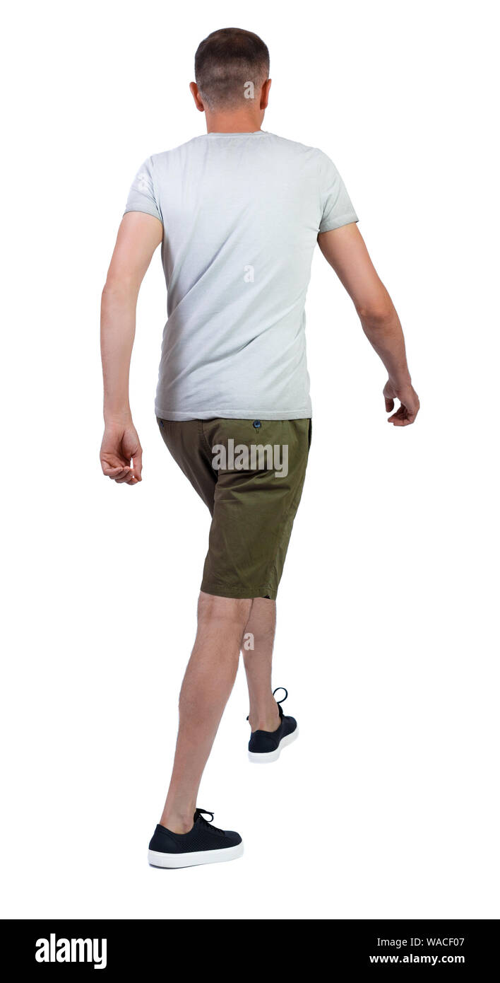 Back view of going handsome man in shorts. walking young guy . Rear ...