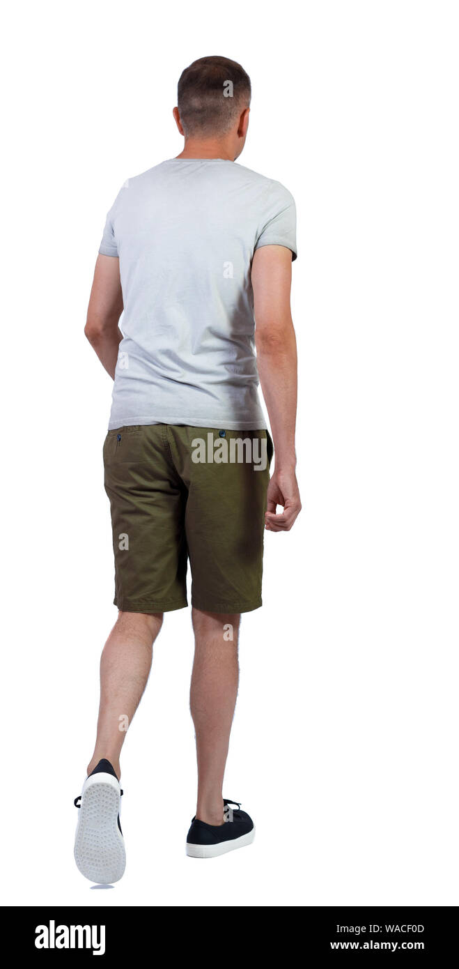Back view of going handsome man in shorts. walking young guy . Rear ...