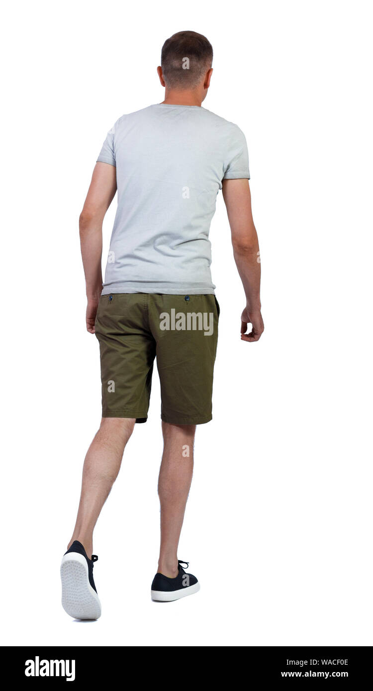 Back view of going handsome man in shorts. walking young guy . Rear ...