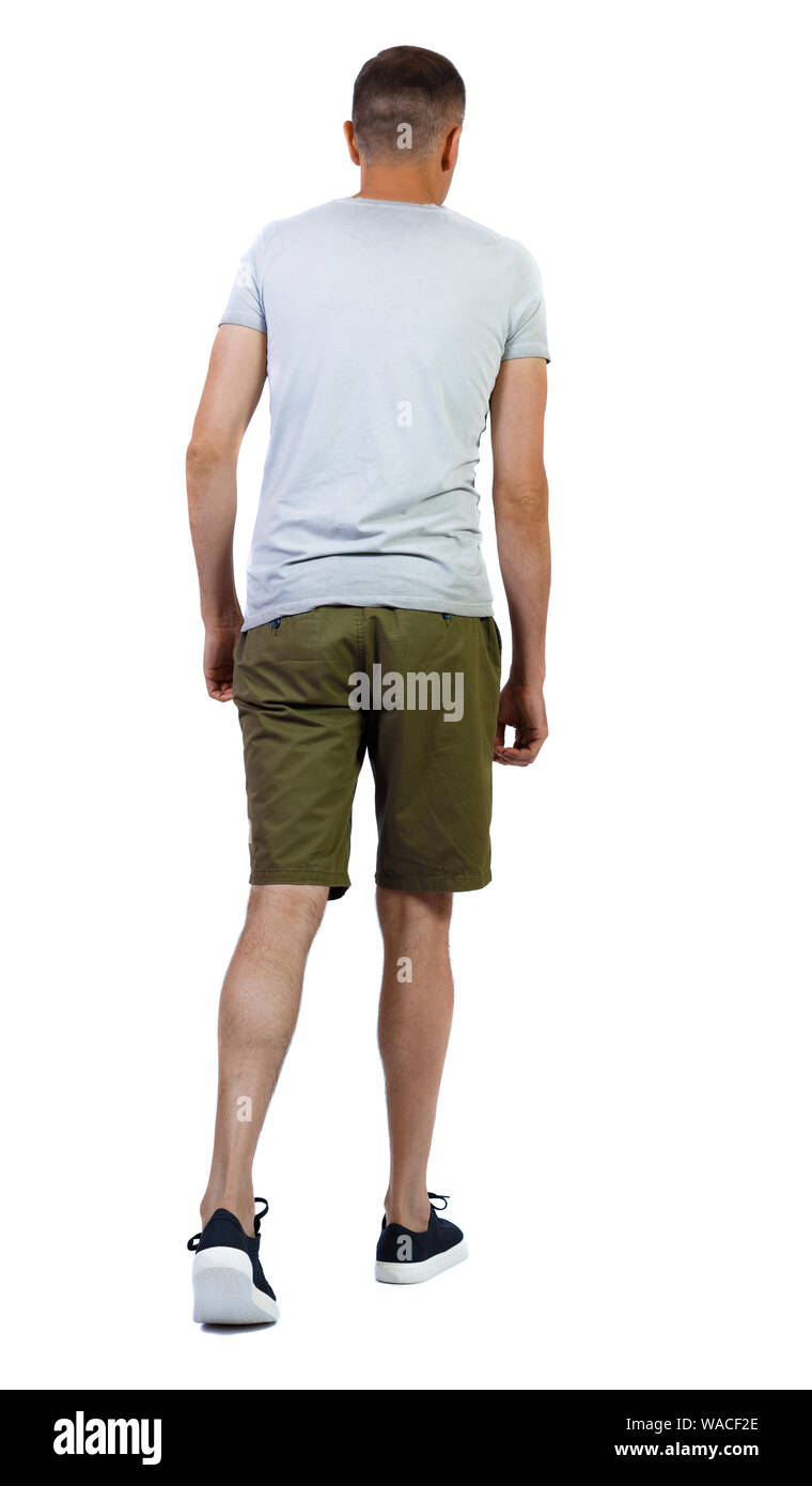 Back view of going handsome man in shorts. walking young guy . Rear ...